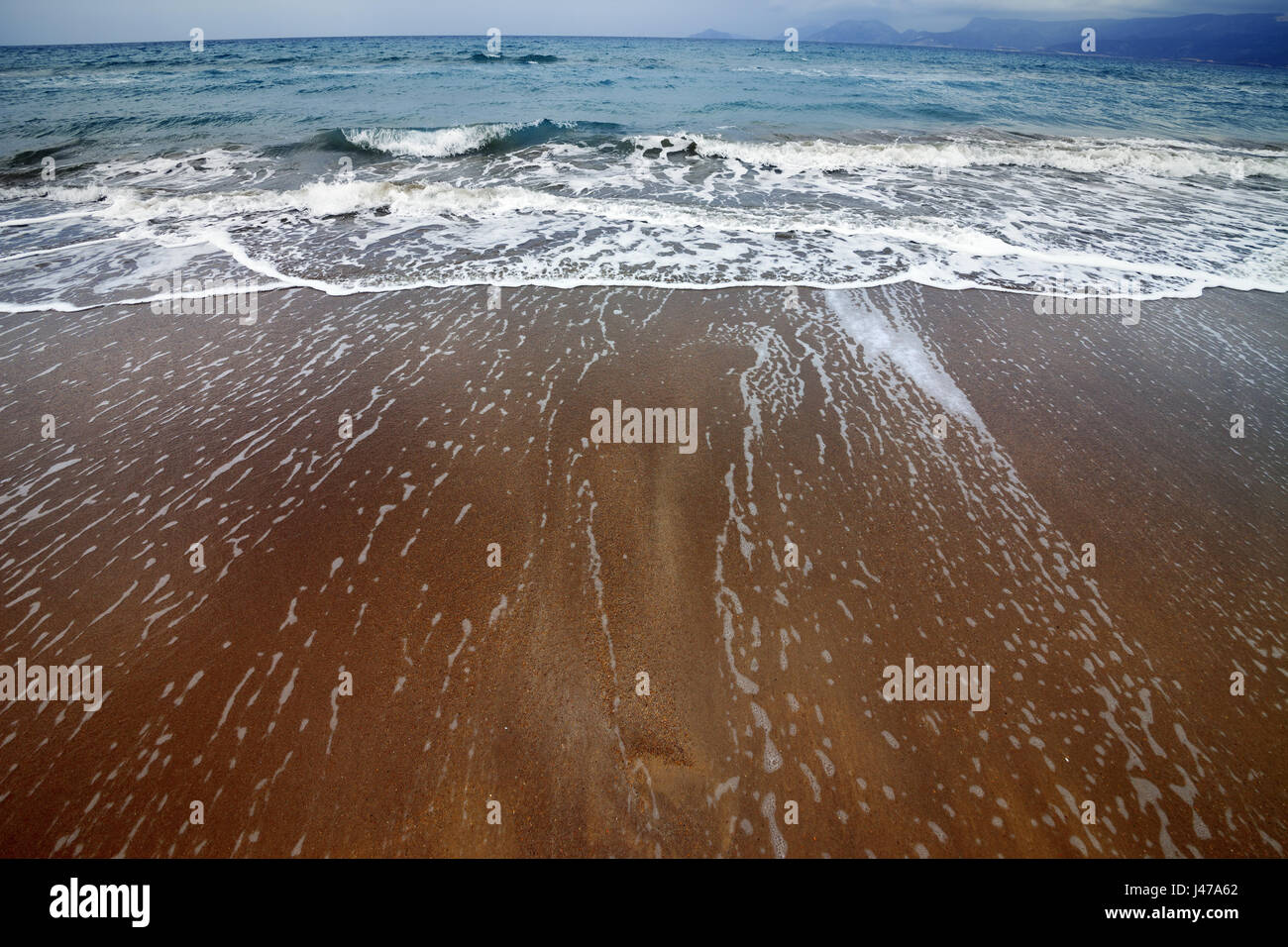 Sea beach with waves in gray day. Wide angle view Stock Photo - Alamy