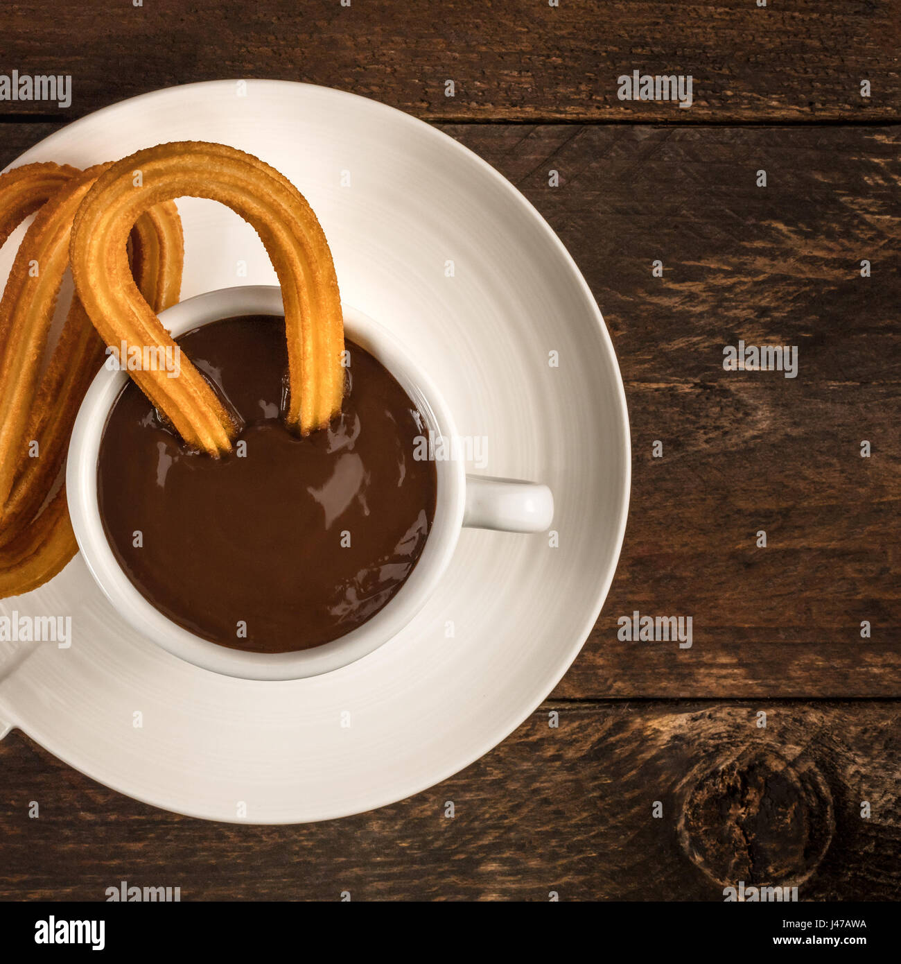 A square overhead photo of churros, traditional Spanish, especially ...