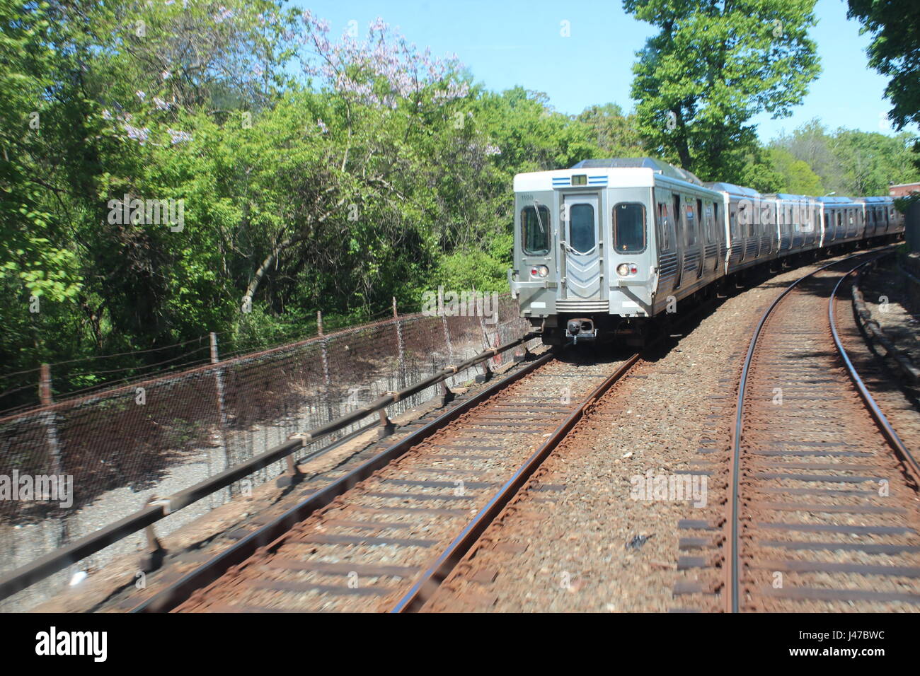 Train arriving on opposite track Stock Photo - Alamy