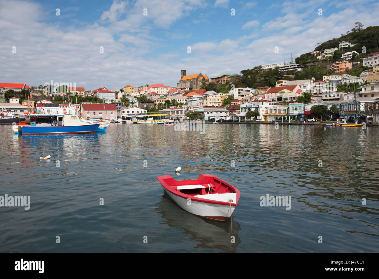 Boats in the Carenage surrounded by colourful buildings on a hill in St ...