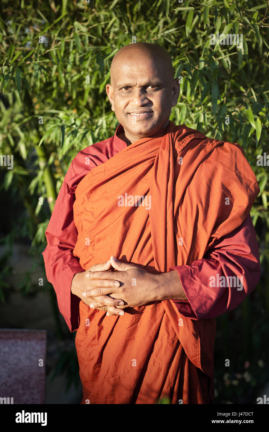 Buddhist monk wearing red robes hi-res stock photography and images - Alamy