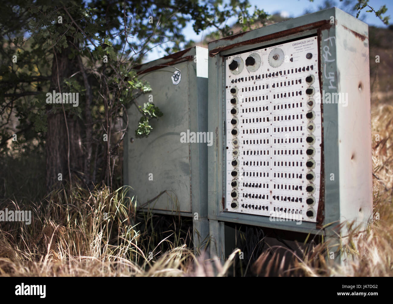 Abandoned rusty antique telecom equipment left in a field covered with ...