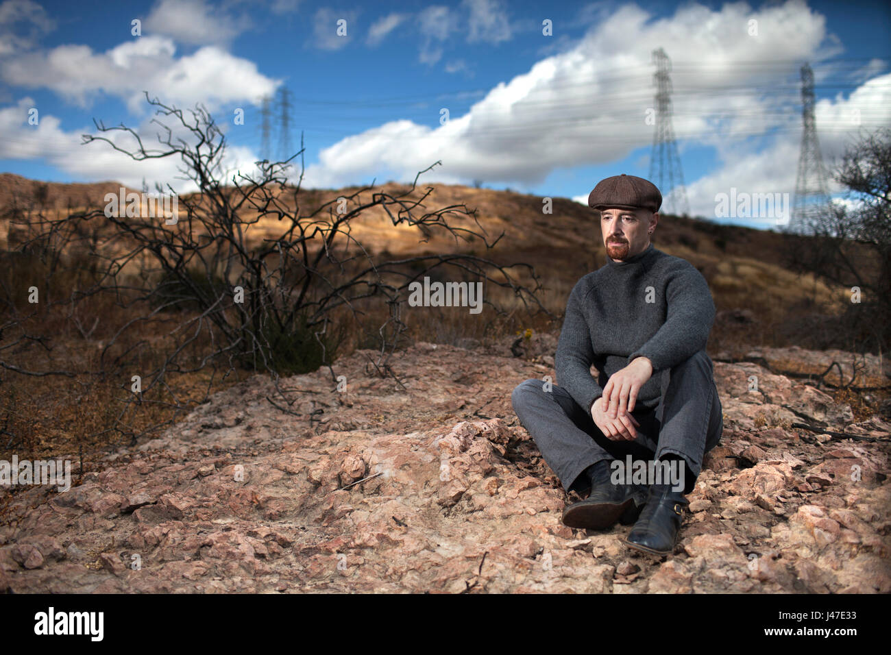 Sad and lonely man with a red goatee wearing a grey wool turtleneck ...
