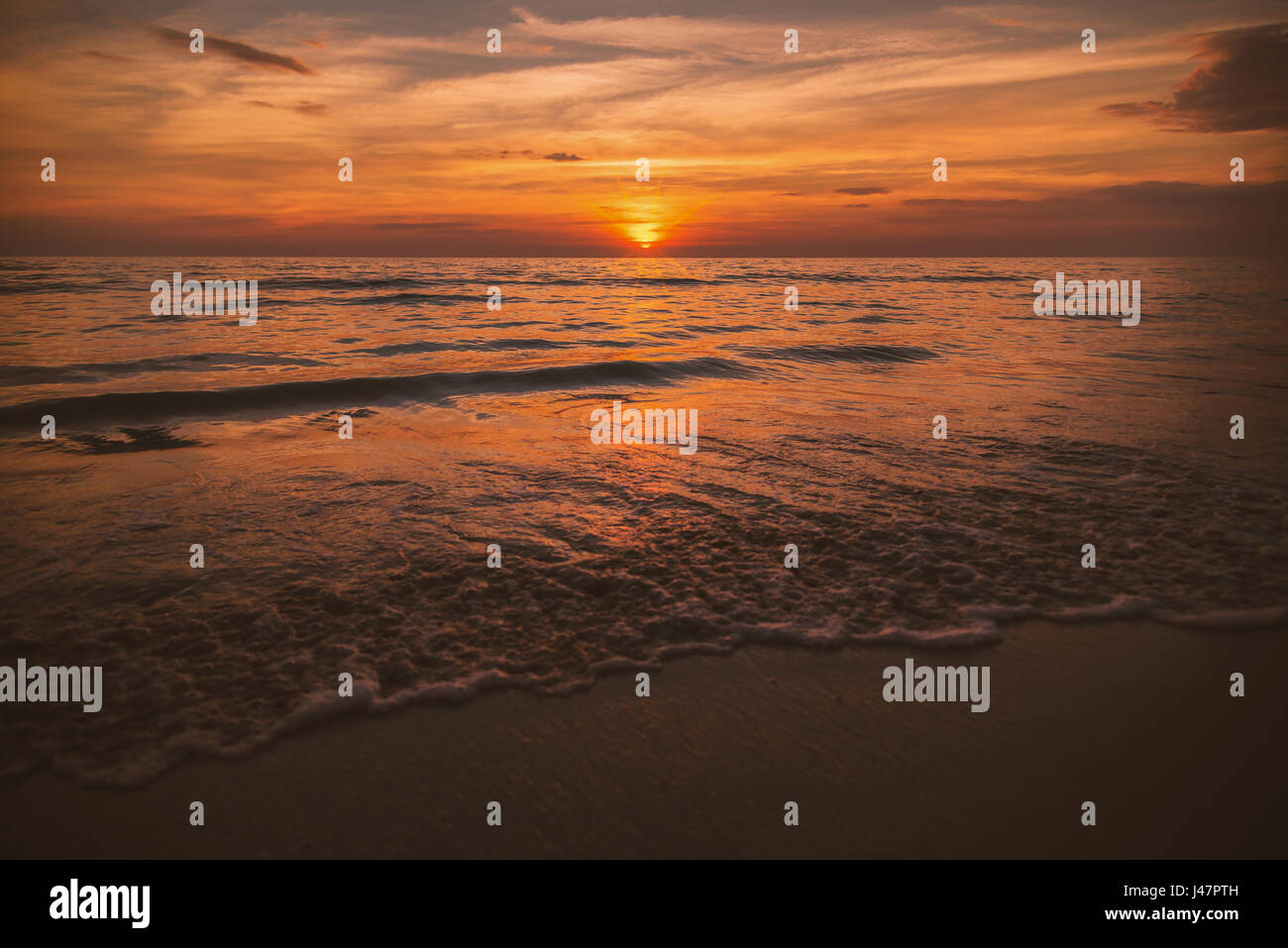 Golden sunrise sunset over the sea ocean waves Stock Photo - Alamy