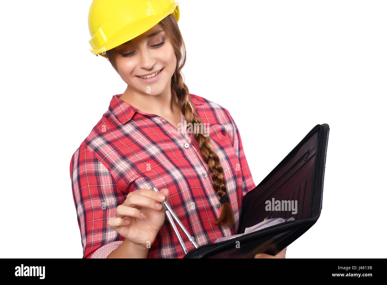 Portrait of beautiful woman construction worker reading blueprints with ...