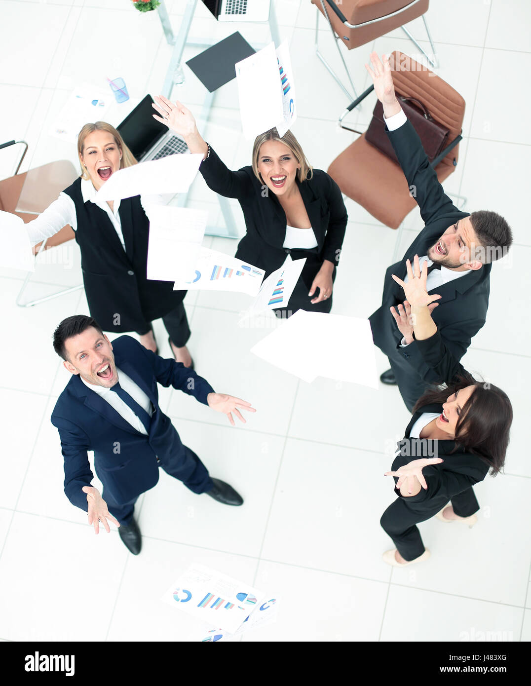 Happy business people throw into the air the documents Stock Photo - Alamy
