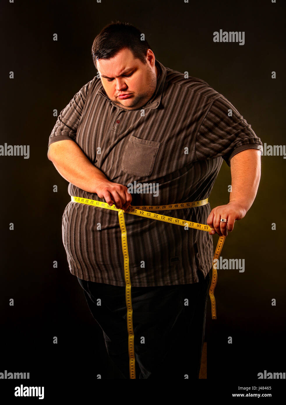 Man belly fat with tape measure weight loss around body Stock Photo - Alamy