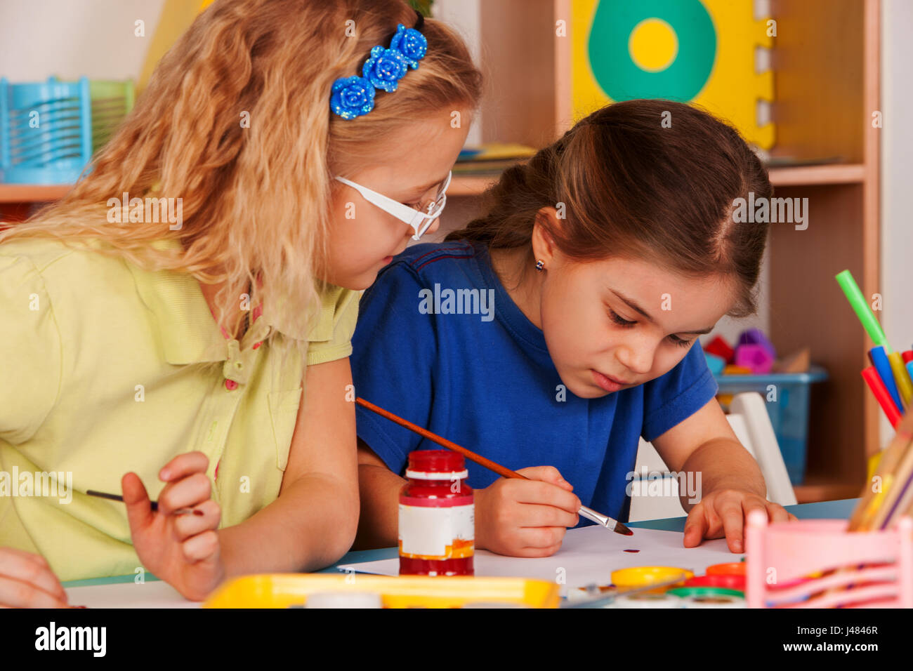 Small students girl painting in art school class Stock Photo - Alamy