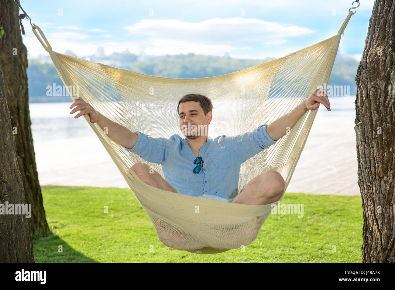 man relaxing in hammock Stock Photo - Alamy