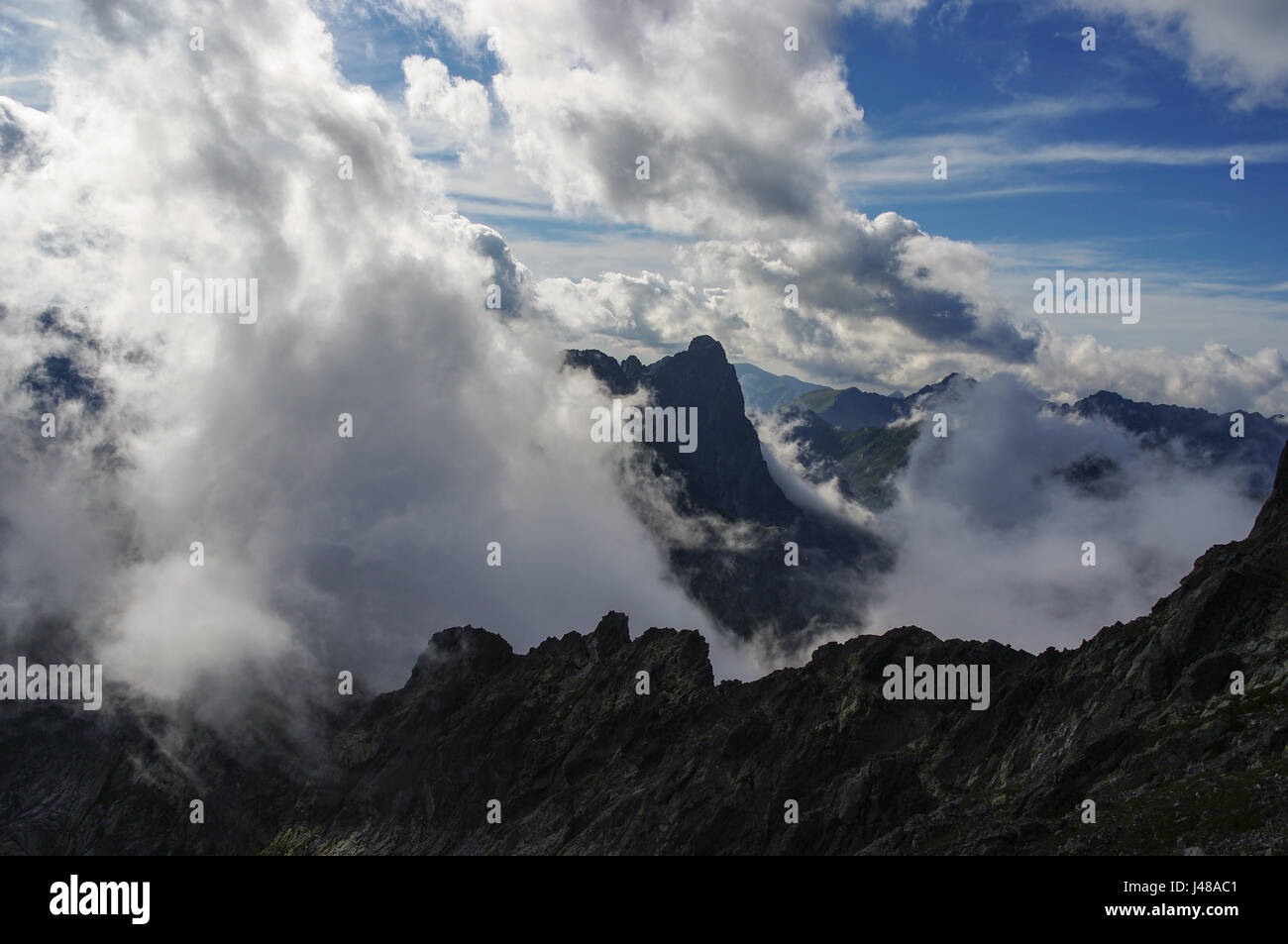 Great clouds on the mountain peaks. Tatry Stock Photo - Alamy