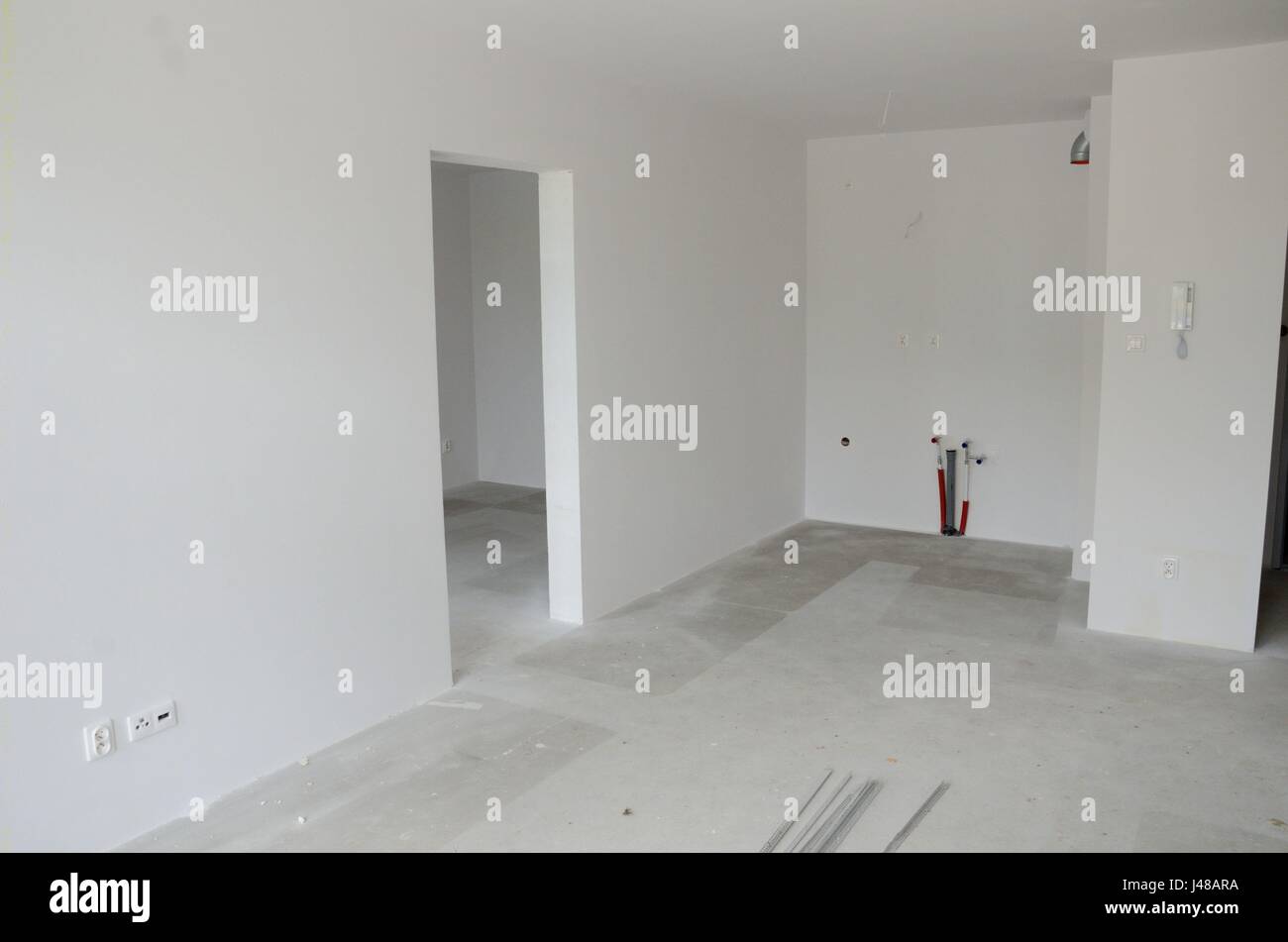 Unfinished, empty apartment without floor, with white walls.Developers ...