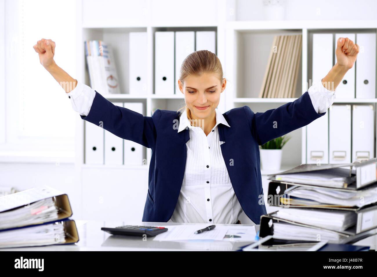 Successful business woman or female accountant with hands up Stock ...