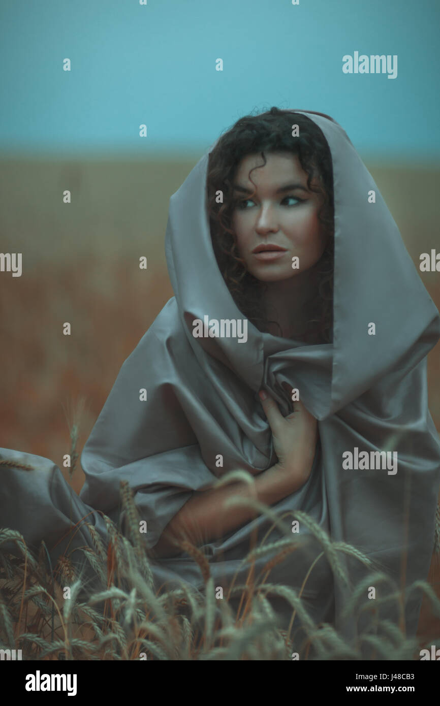 Portrait of a girl with a cloth on his head sticking out from under ...