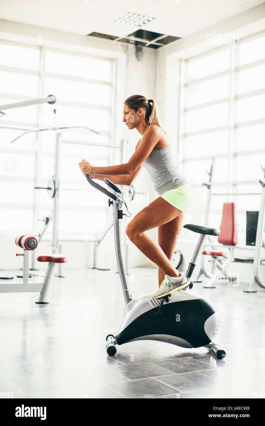 Woman riding exercise bike hi-res stock photography and images - Alamy