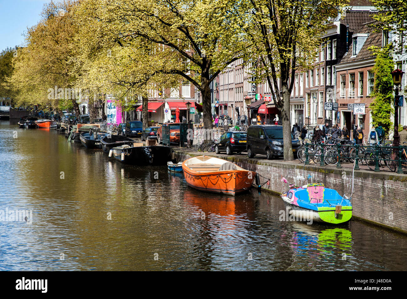 Amsterdam canal view with small boats. Spring day in the city Stock ...