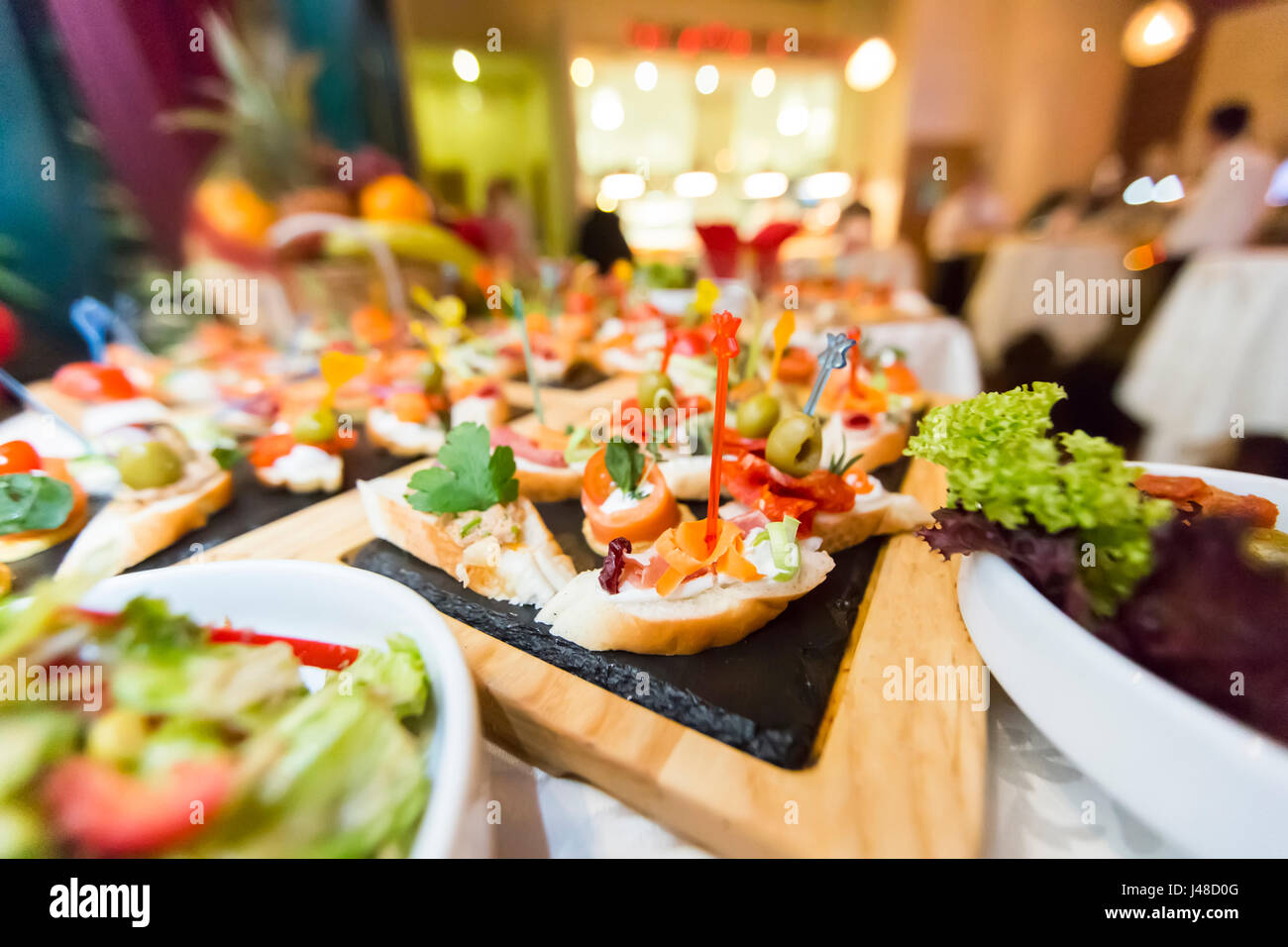 Beautifully decorated catering banquet table with different food snacks ...