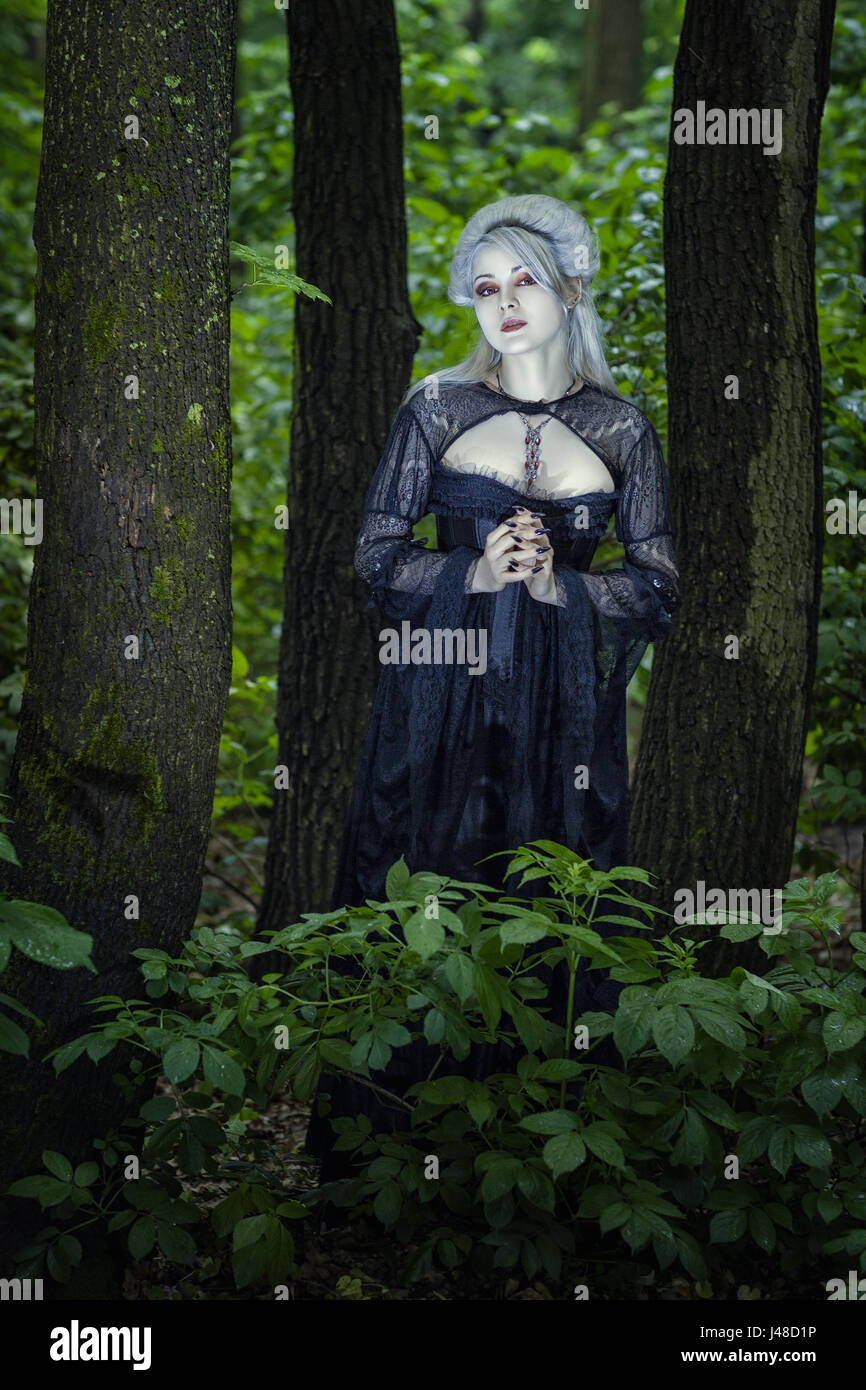 Beautiful young blond woman alone in the woods like a ghost Stock Photo ...