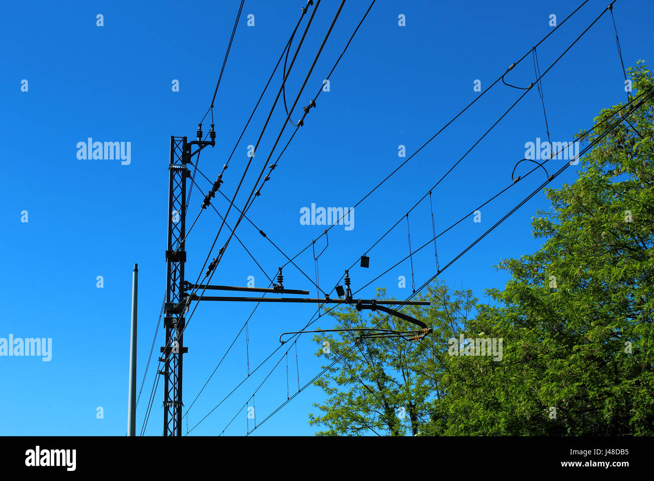 Modern railway wires against blue sky Stock Photo - Alamy