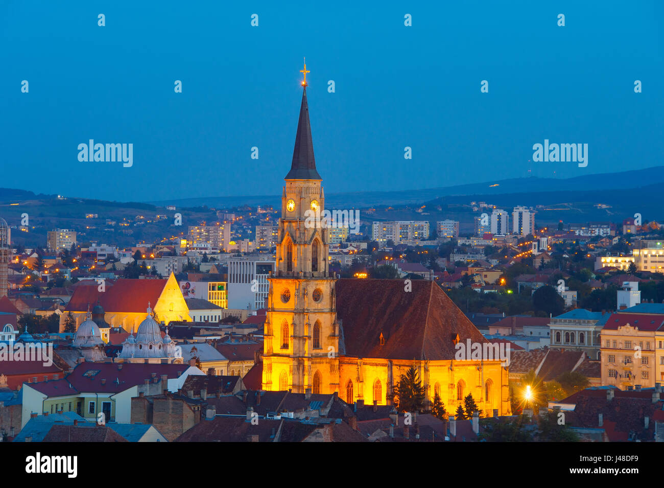 Skyline of Cluj-Napoca with the church of Saint Michael at twilight ...