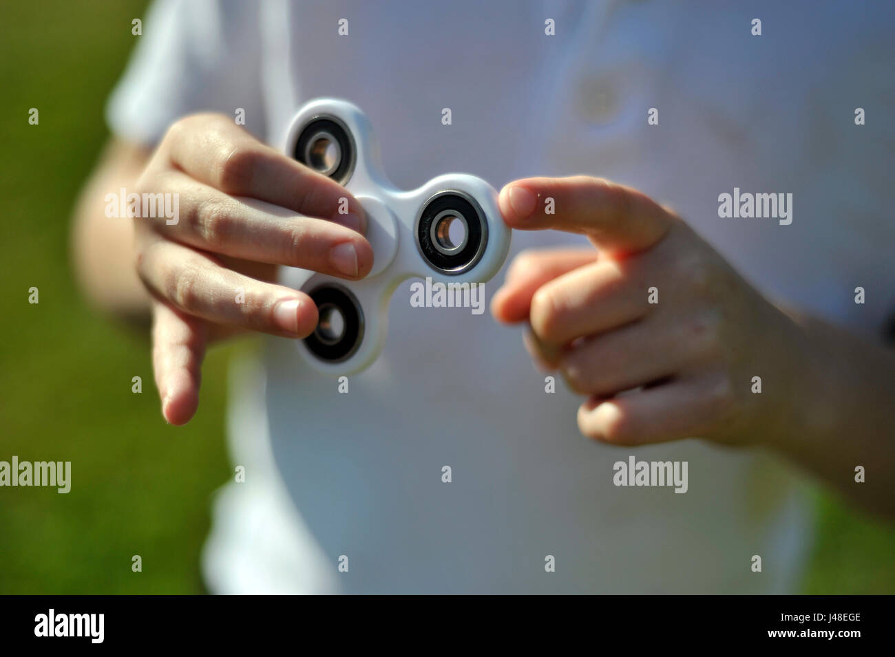 Boy playing fidget spinner hi-res stock photography and images - Alamy