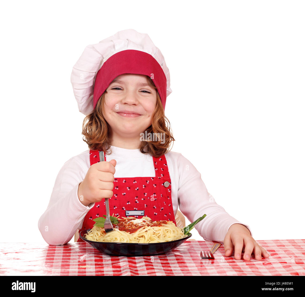 happy little girl cook eat spaghetti Stock Photo - Alamy