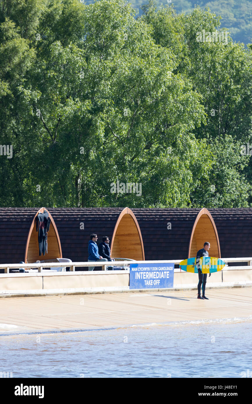 A surfer holding surf board at the artificial wave pool in the Conwy ...