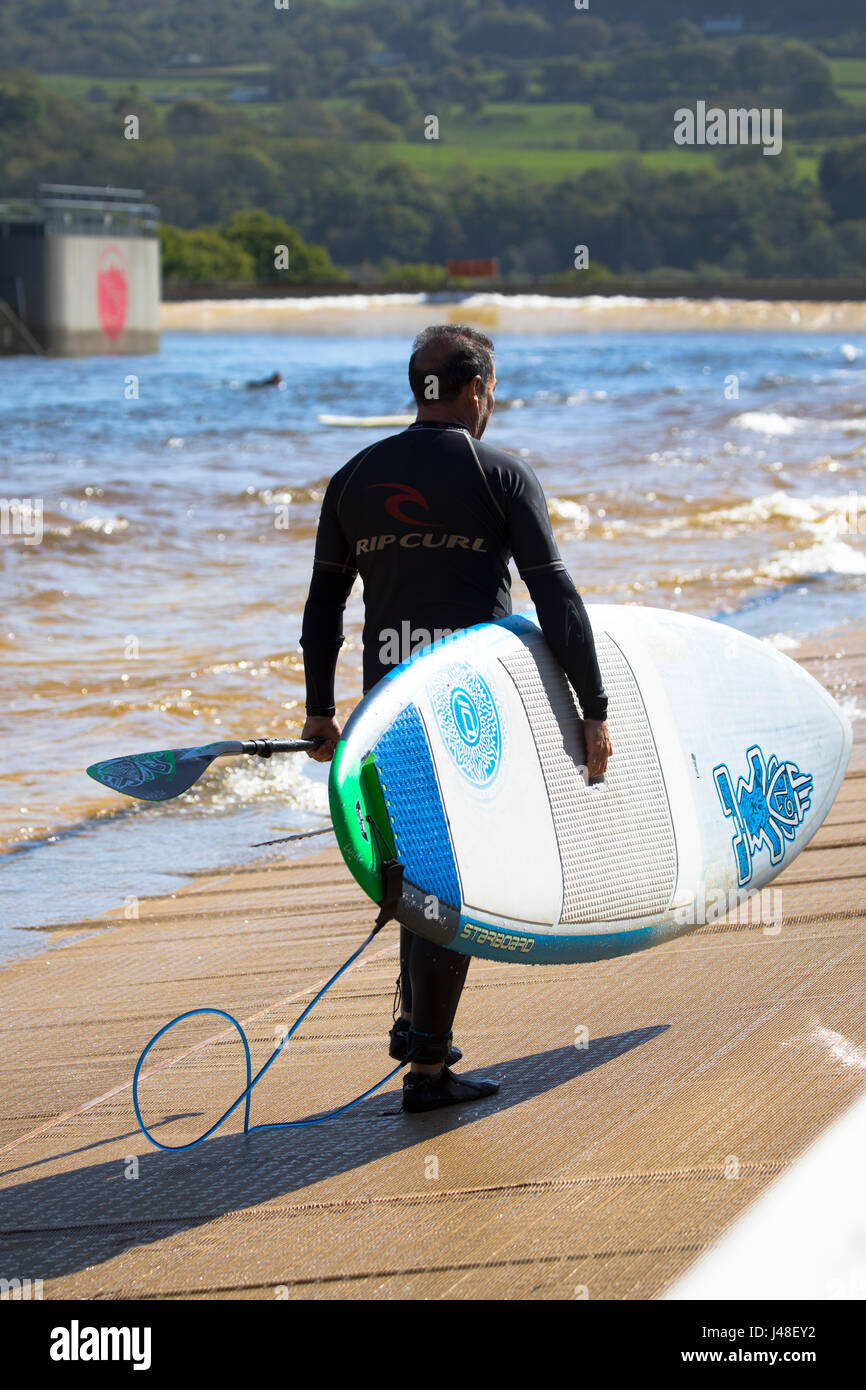 Man walking with a surf board hi-res stock photography and images - Alamy