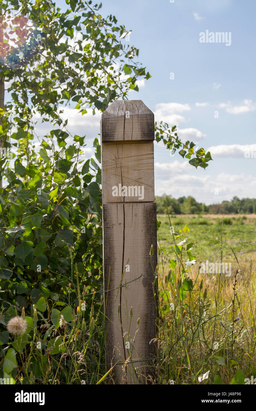 a Image wooden pillar at the border of the field Stock Photo - Alamy