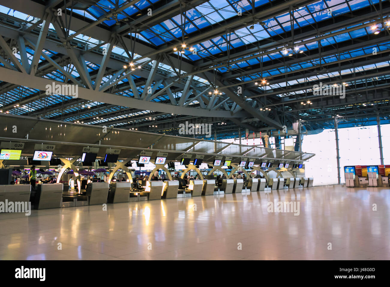Passengers in an international airport terminal, traveling and ...