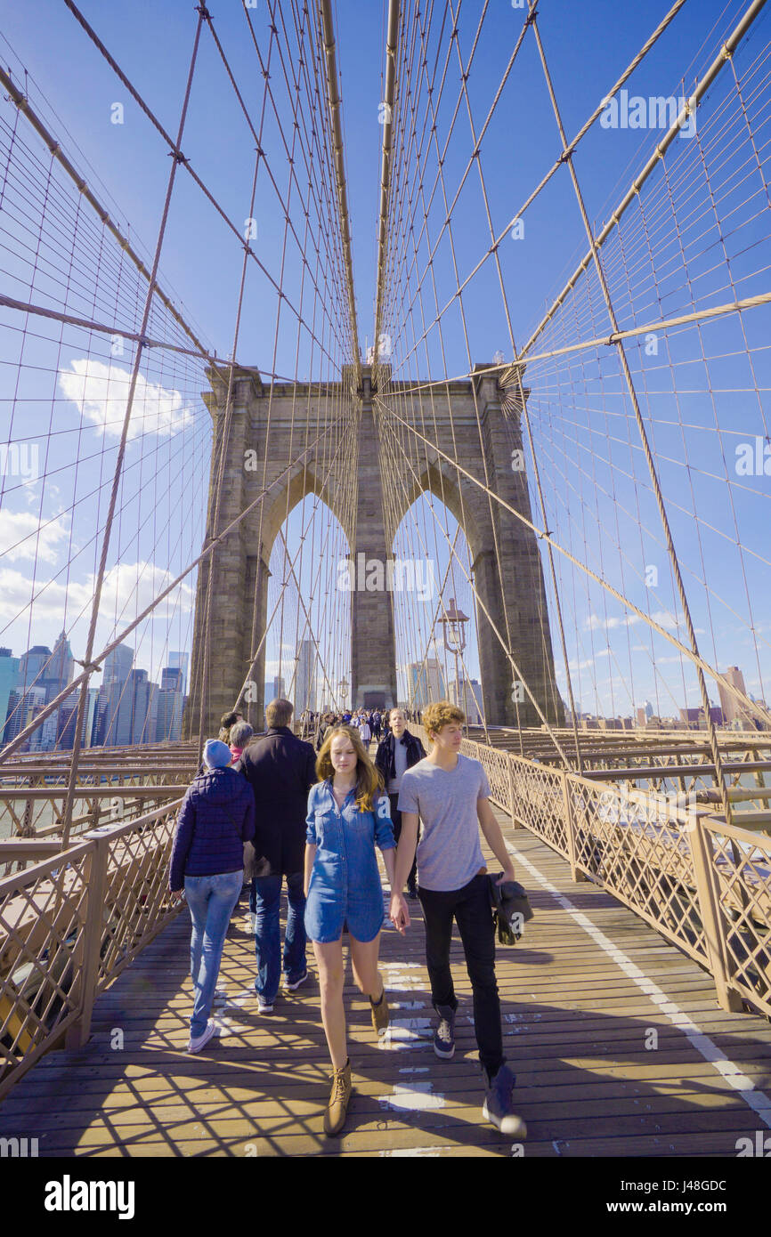 People walking over beautiful Brooklyn Bridge in New York- MANHATTAN ...
