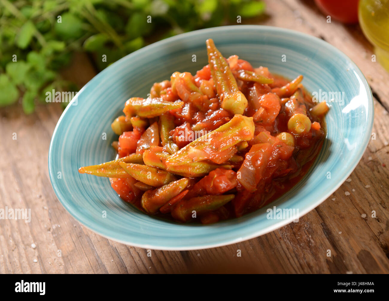 Okra dish with tomatoes (Traditional greek, romanian, bulgarian and ...