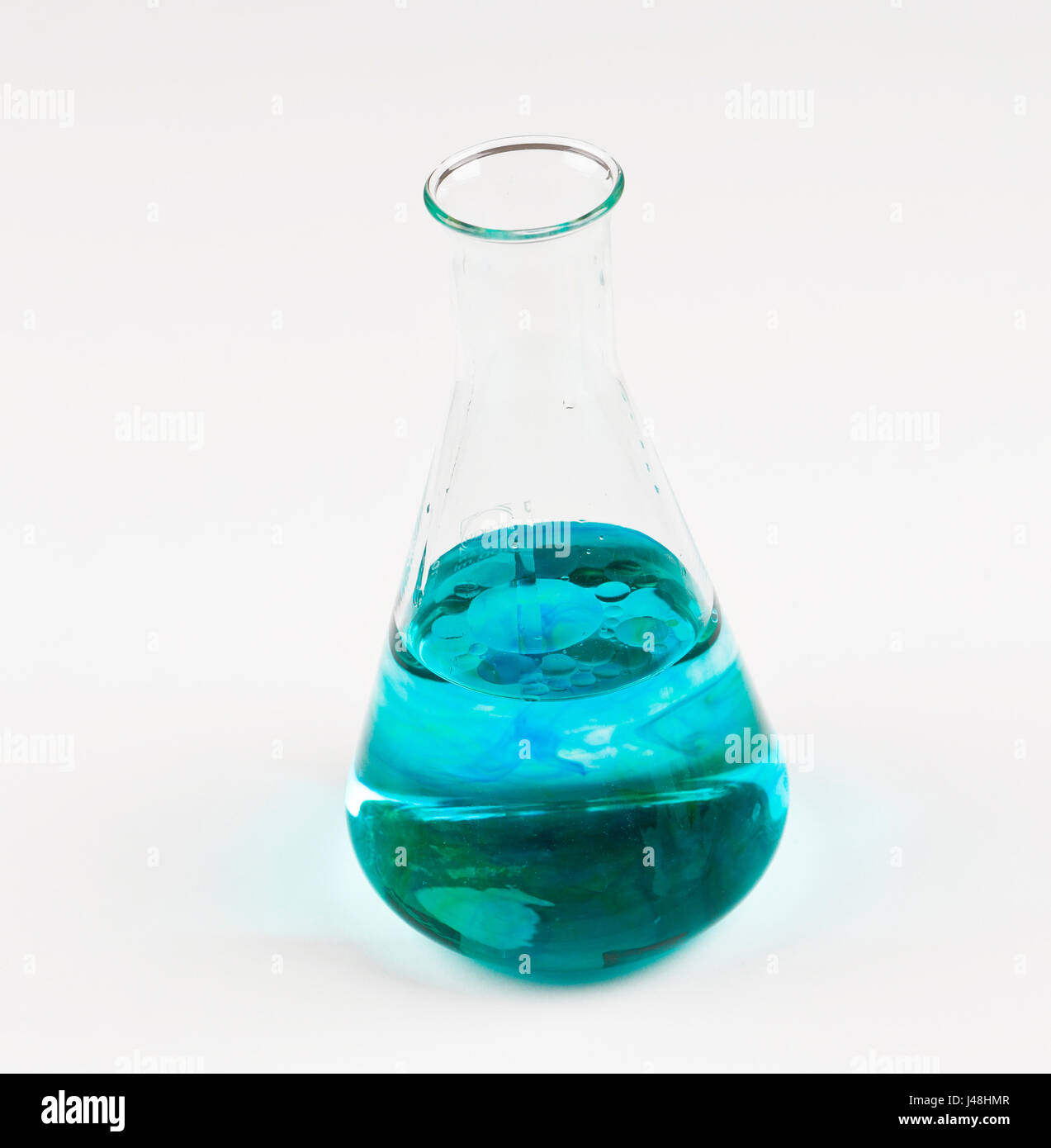 Flask with blue liquid and white background Stock Photo - Alamy