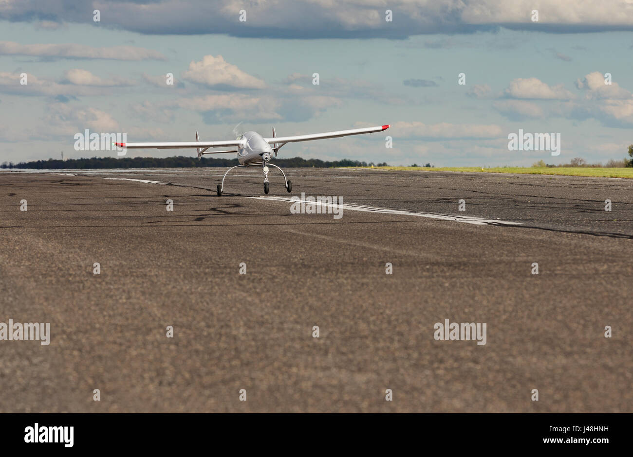 Unmanned aerial vehicle (UAV) starts from the asphalt runway Stock ...