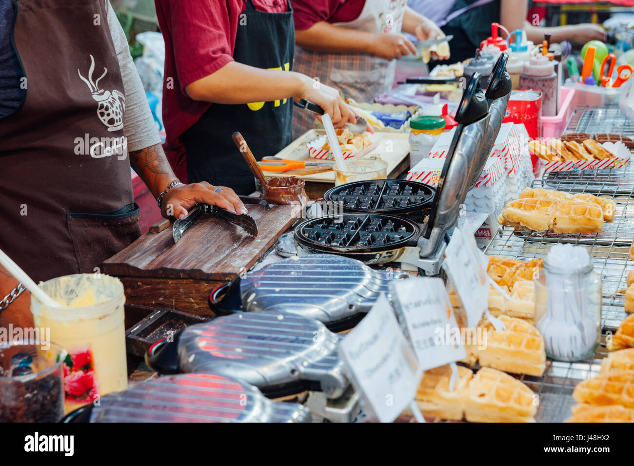CHIANG MAI, THAILAND - AUGUST 21: Chefs cooks and sells waffles at the ...