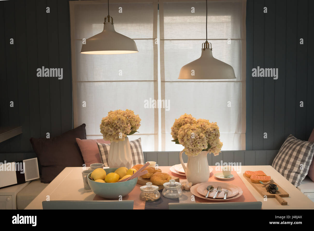 The white lamp hanging from the ceiling floor over dining table Stock ...