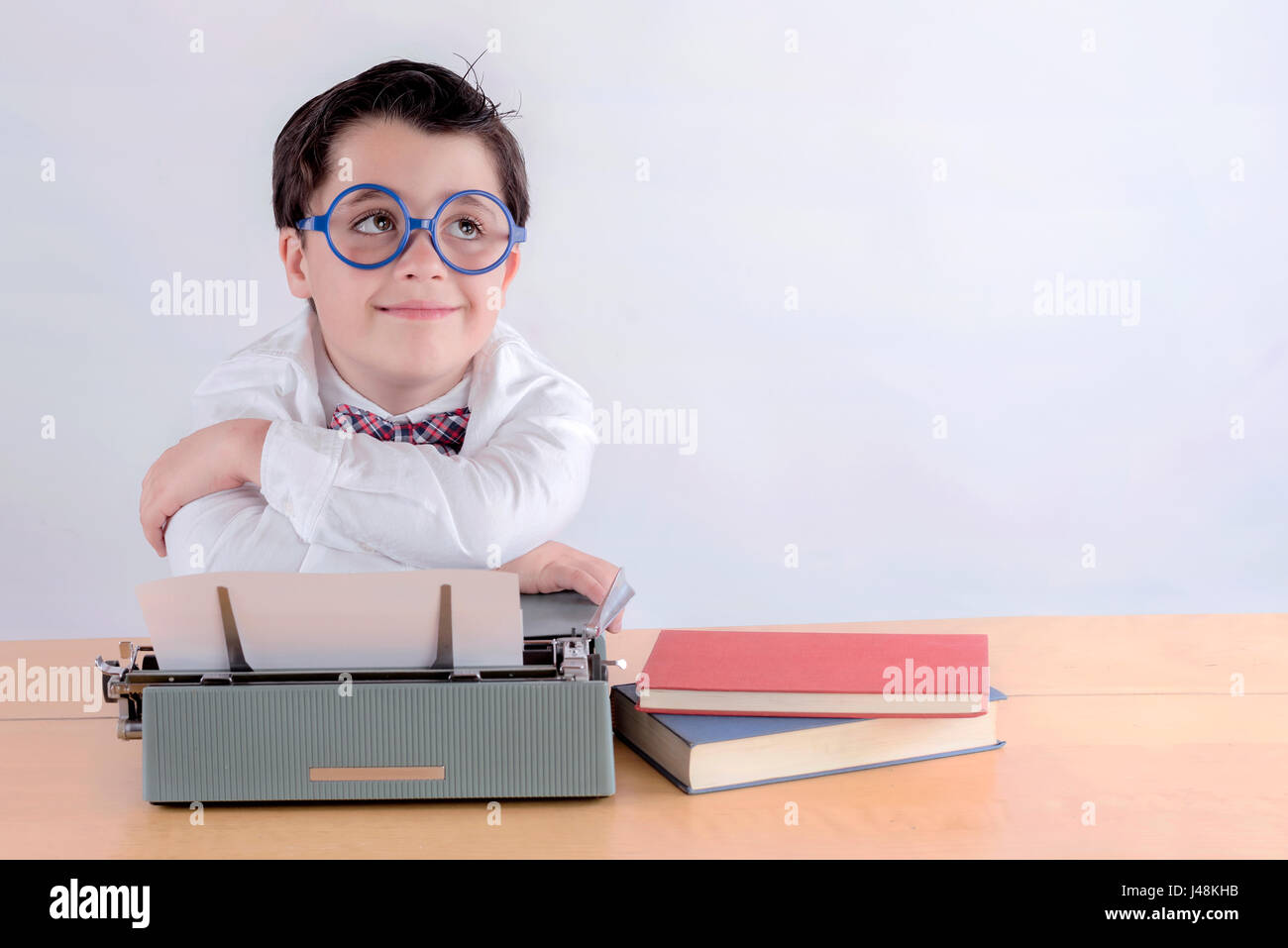 Smiling boy with typewriter Stock Photo - Alamy