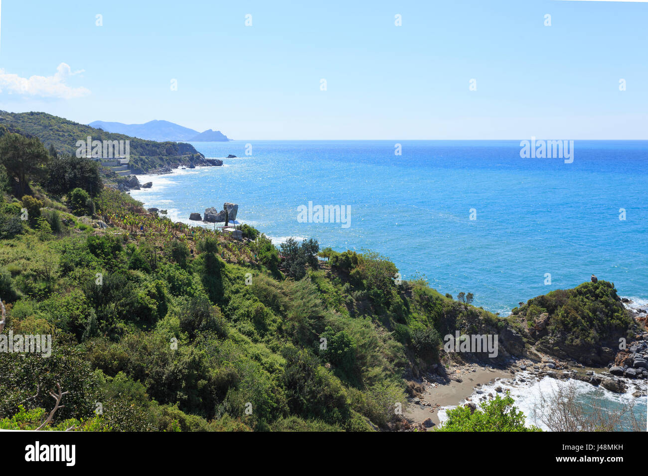 Seascape of Mediterranean coast with rocks and hills descending to sea ...