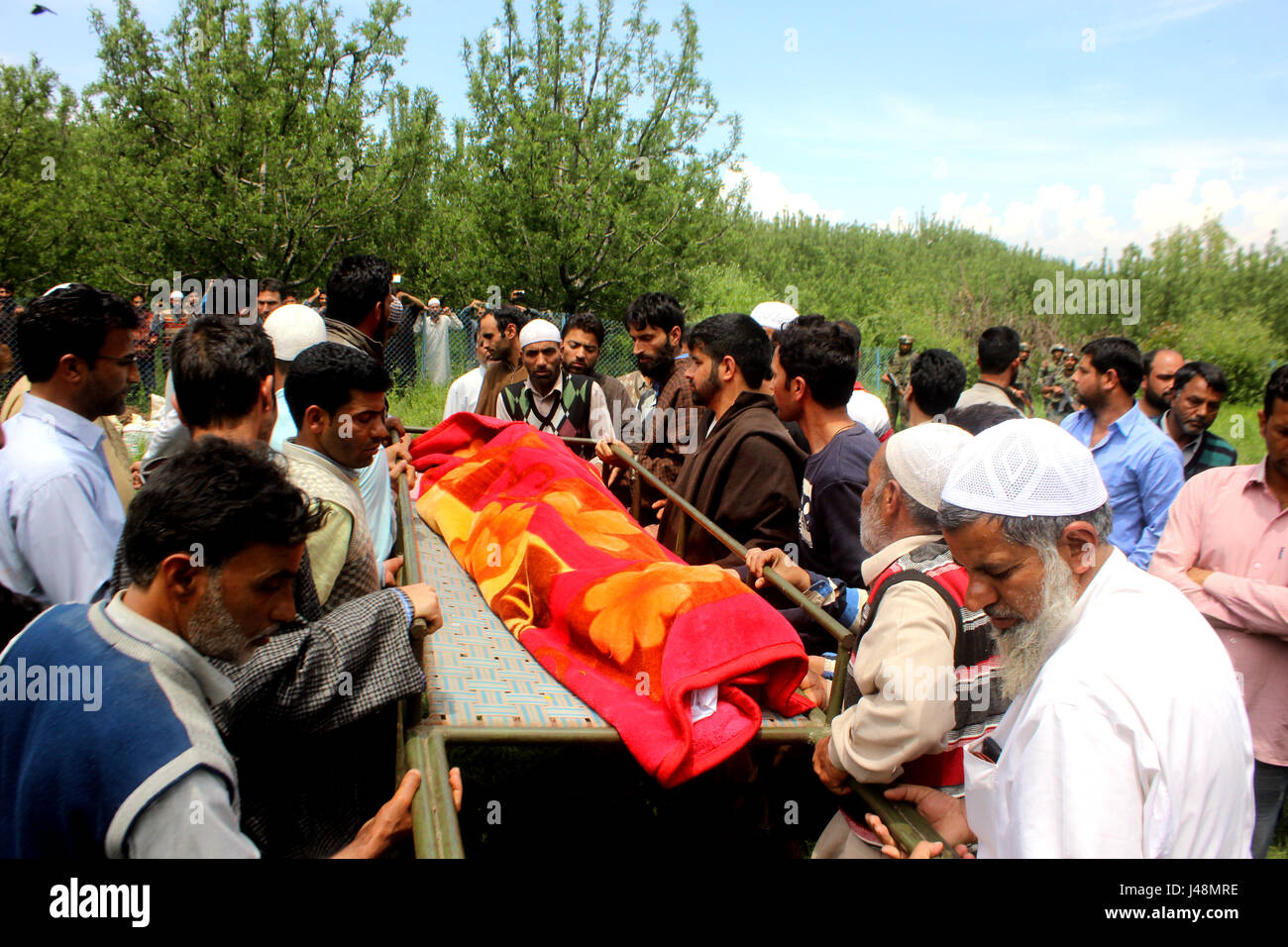 Kashmiri villagers carry the body of slain army officer Umer Fayaz Parry at Sudsoona Yaripora in ...