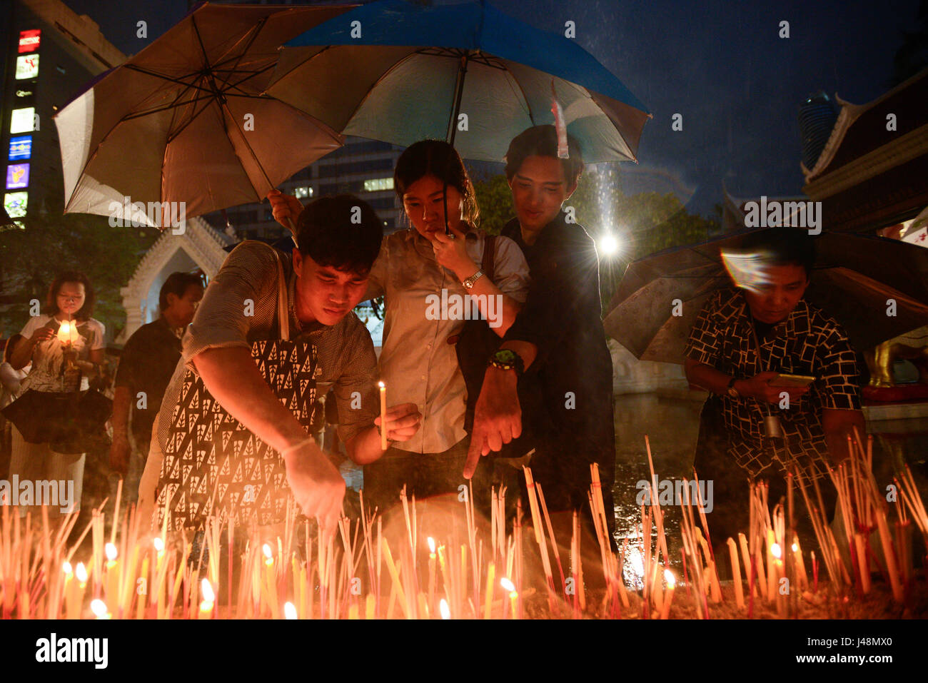 Thai Buddhist a candle to celebrate during a ceremony marking Visakha ...