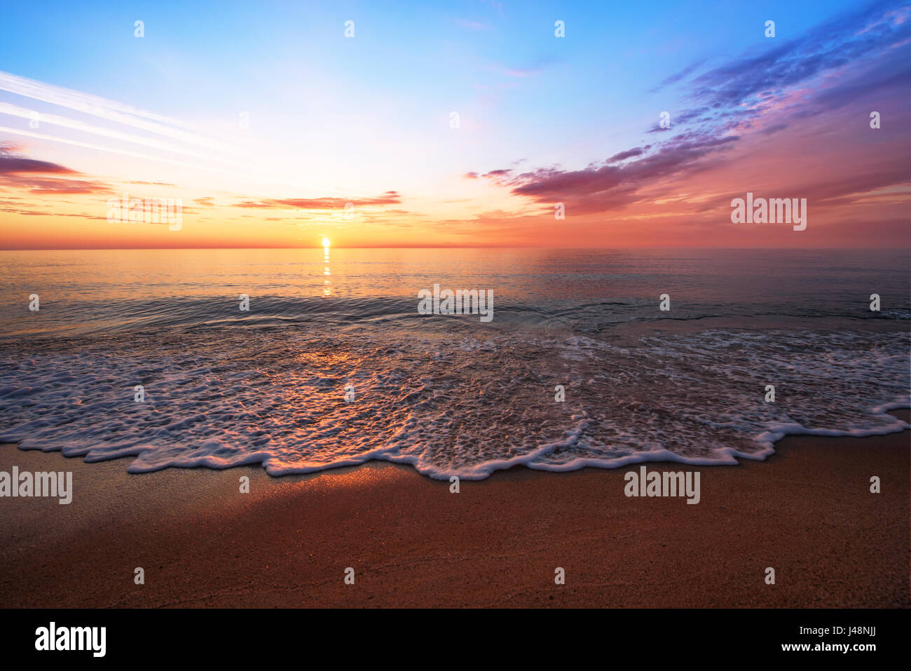 Beautiful tropical sunrise on the beach Stock Photo - Alamy