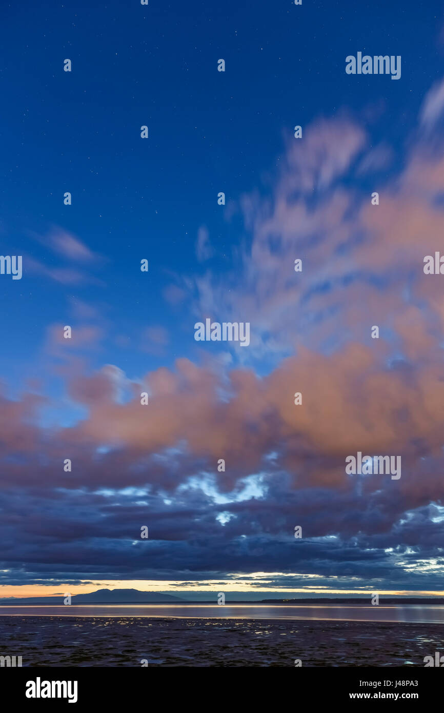 Scenic of sunlit clouds above the mud flats along Cook Inlet, Anchorage ...