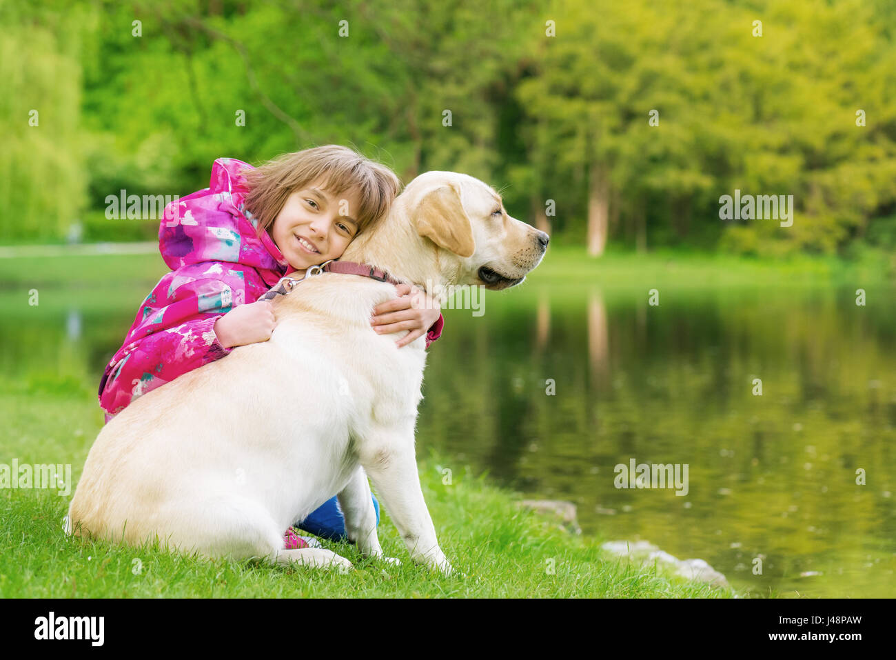 Girl with labrador retriever dog Stock Photo - Alamy