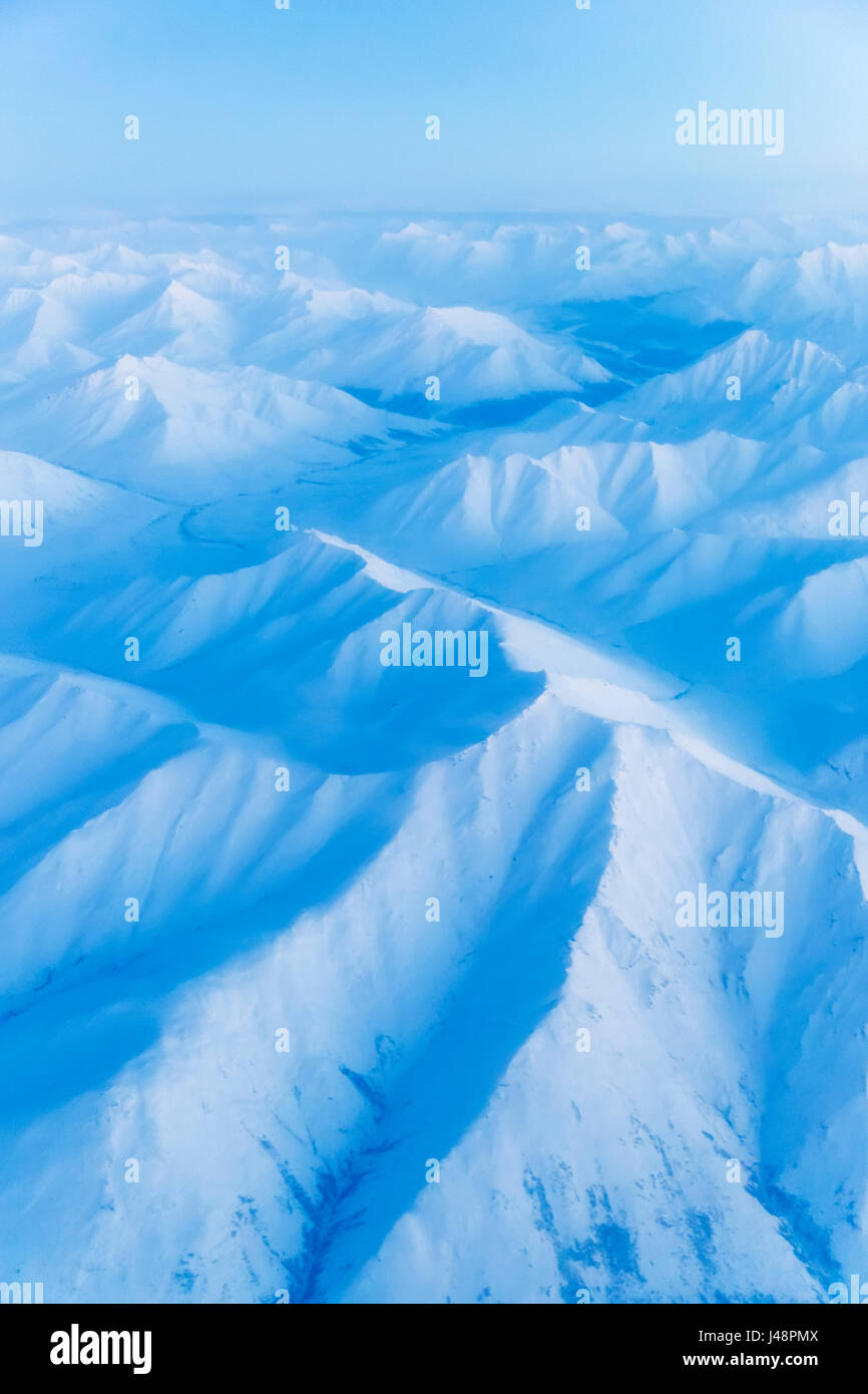Aerial view of the snow covered mountains in the Brooks Range at ...