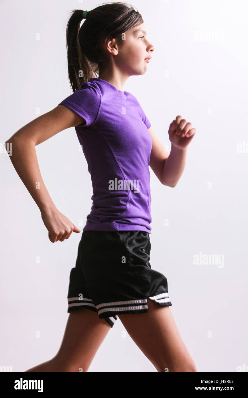 A teenage girl running against a white background; Oregon, United ...