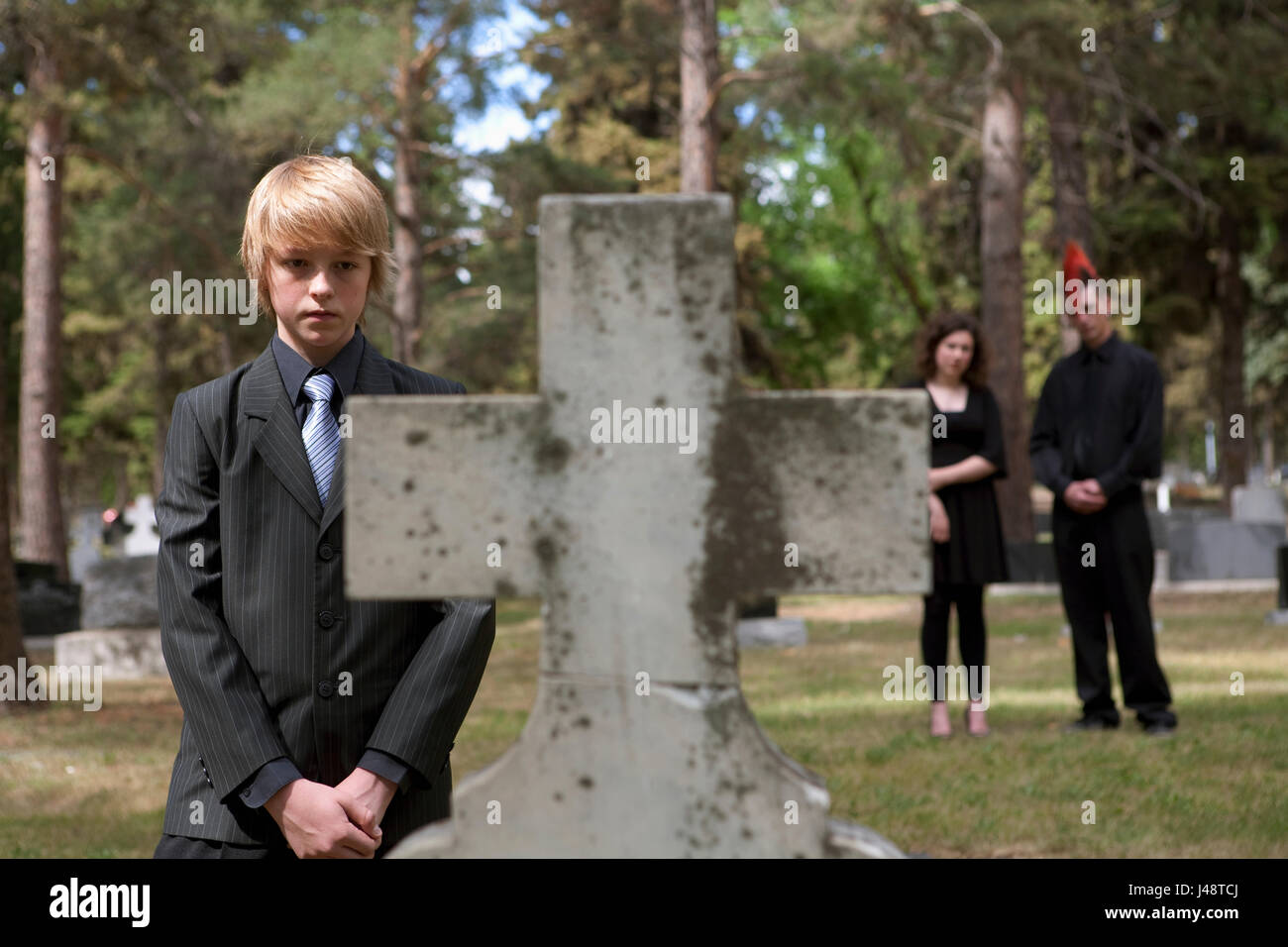 A Teenage Boy Visiting A Tombstone In A Cemetery; Edmonton, Alberta ...