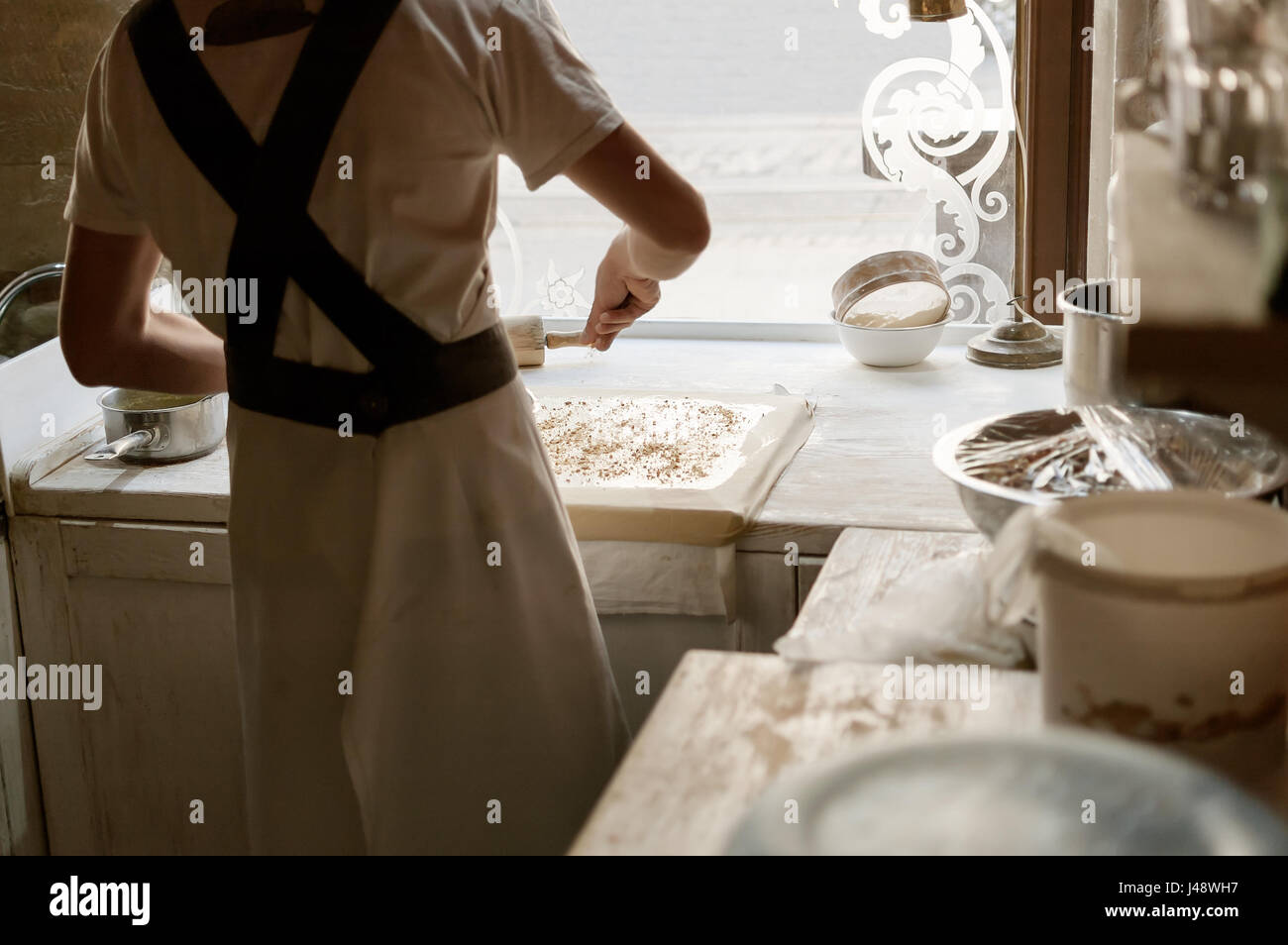 Baker is making a cake. Sprinkle sweets. Cooking process Stock Photo ...