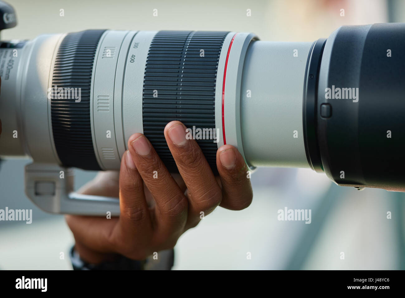photographer with camera in hand looking through the camera lens Stock ...