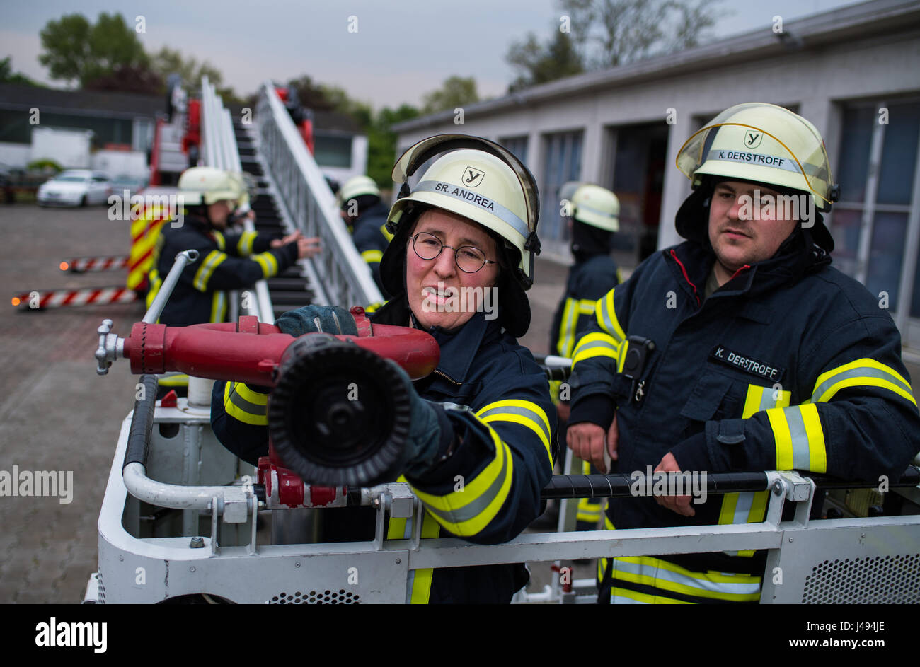 Sister Andrea Stadermann installs the water cannon with firefighter ...