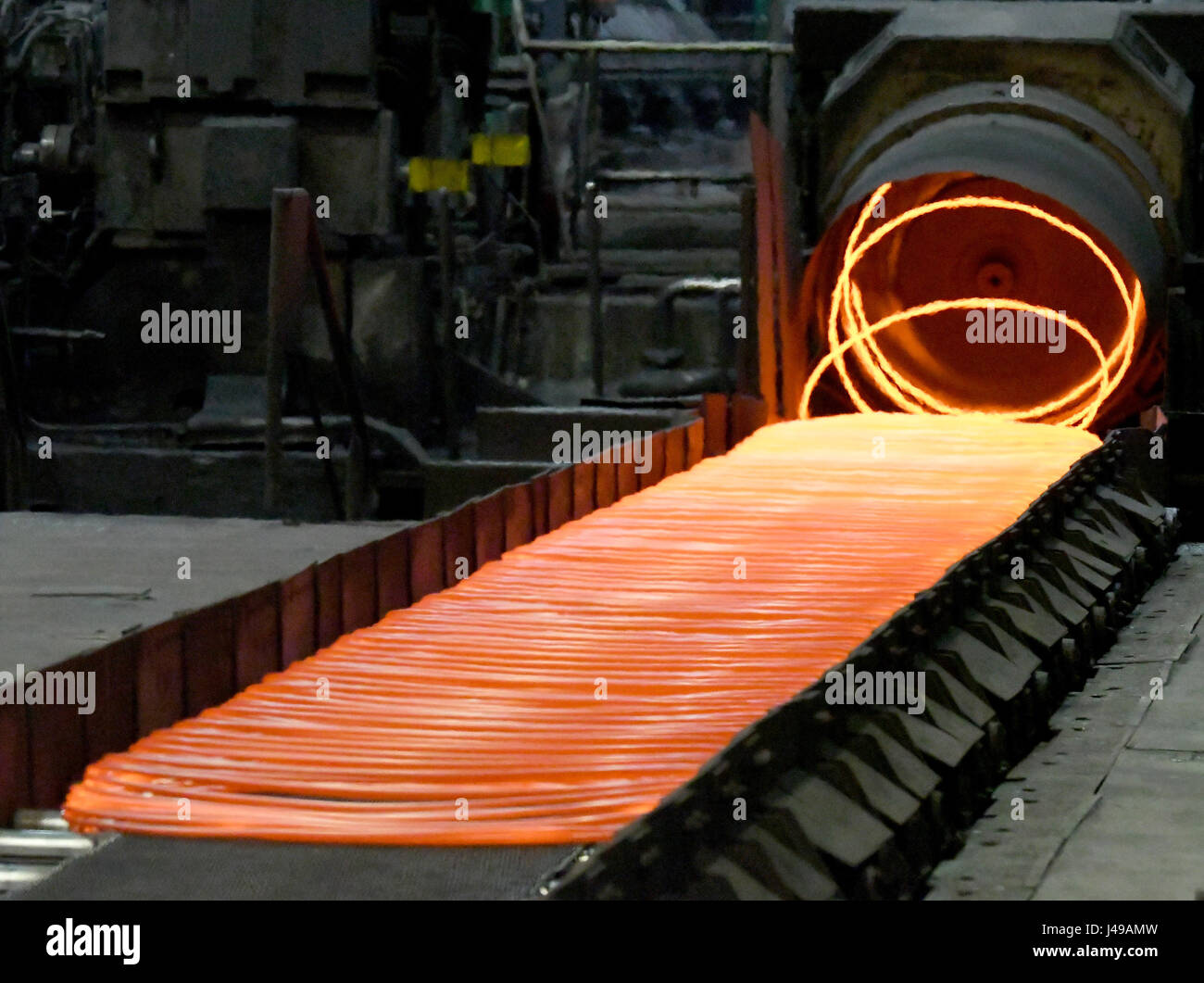 Steel being lain spirally at 900 degrees of temperature at the ...