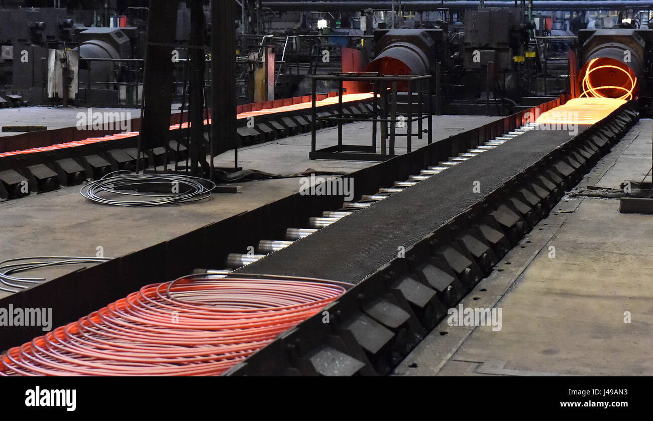 Steel being lain spirally at 900 degrees of temperature at the ...